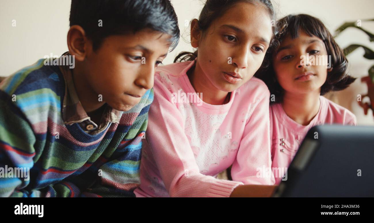 Closeup of the group of children looking at the tablet screen Stock ...
