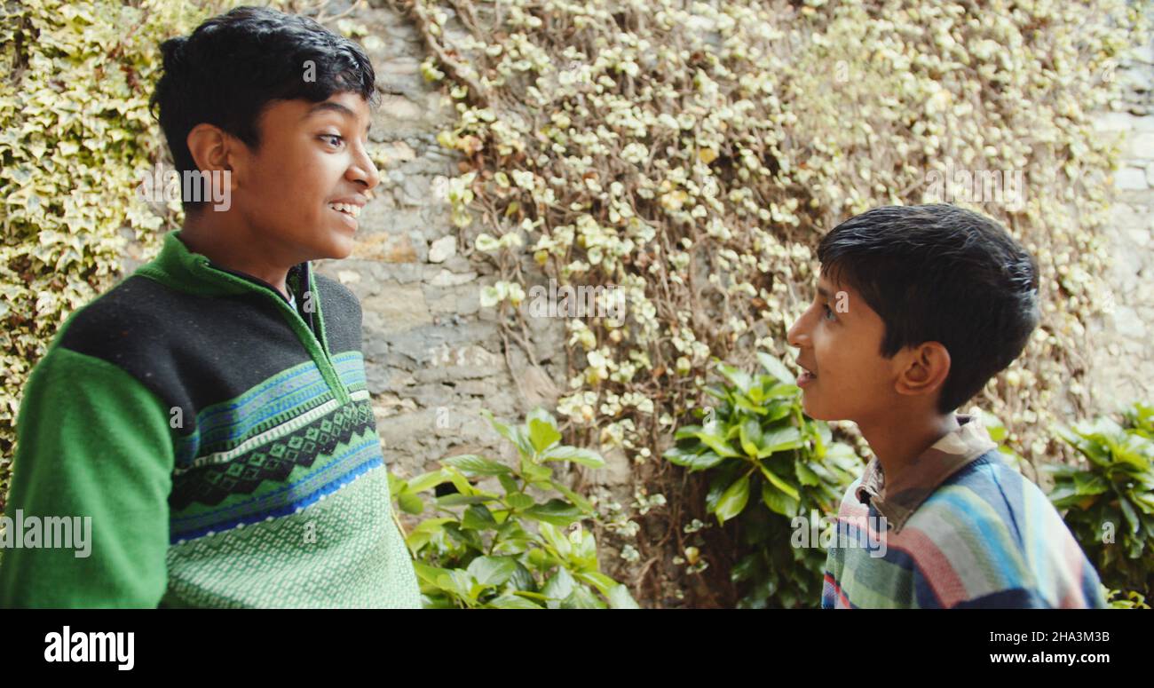 Closeup of the young boys talking to each other Stock Photo - Alamy