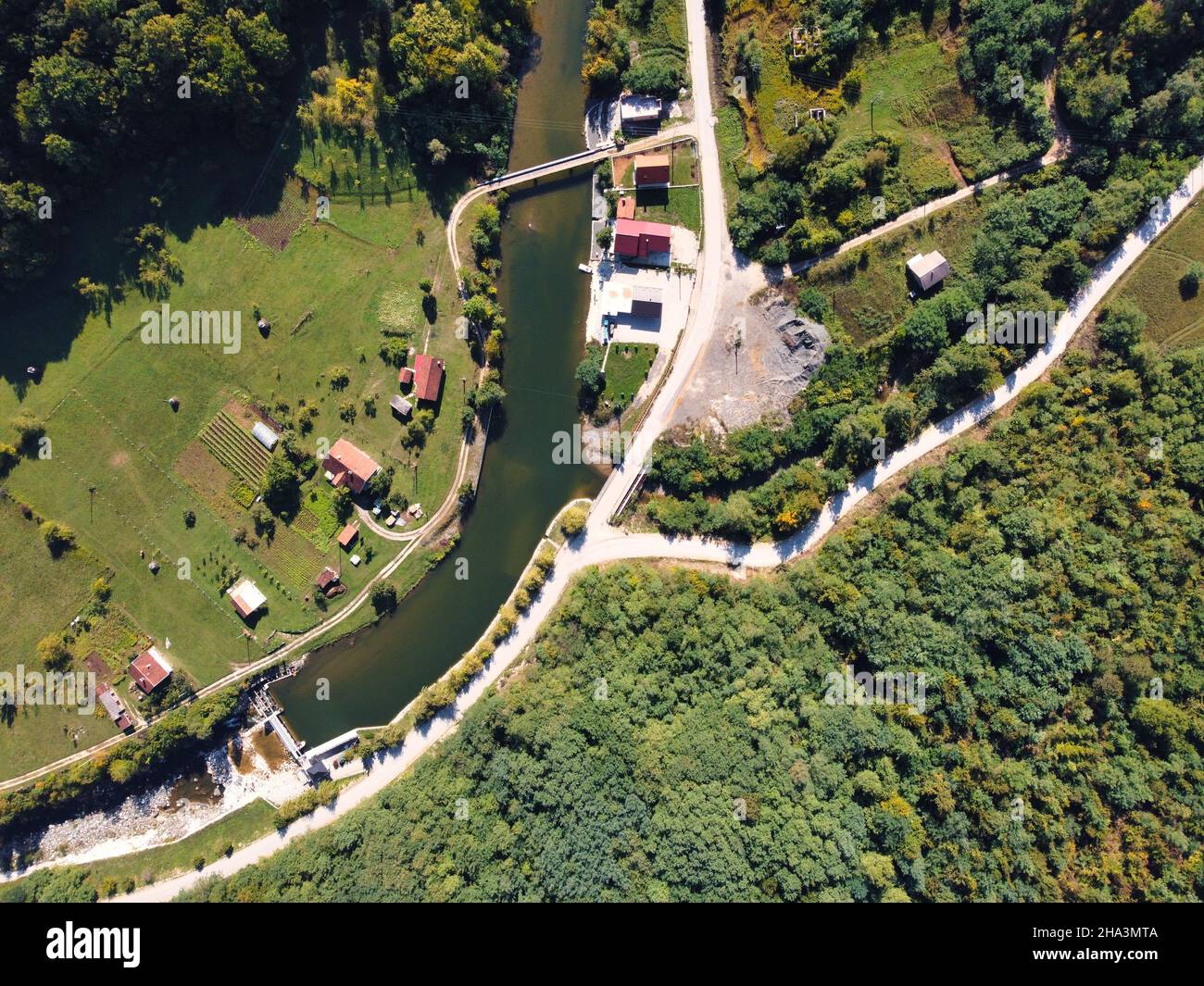 Aerial view of a narrow river flowing through a small town Stock Photo ...