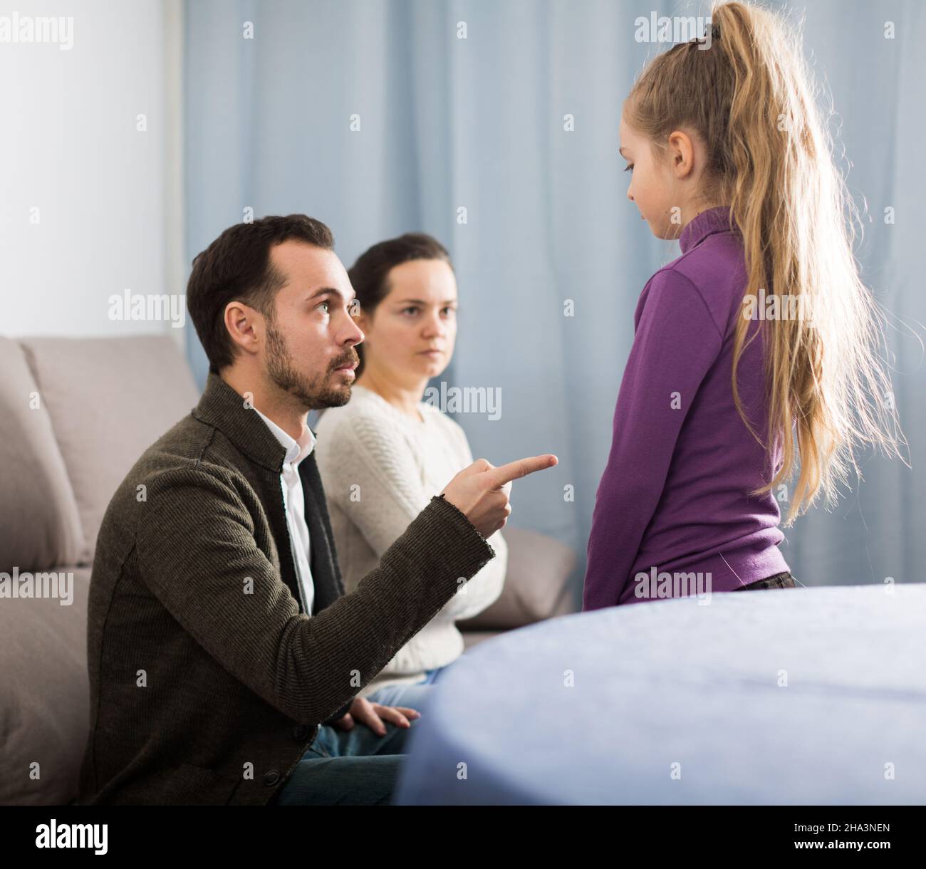 Parents lecturing daughter Stock Photo - Alamy
