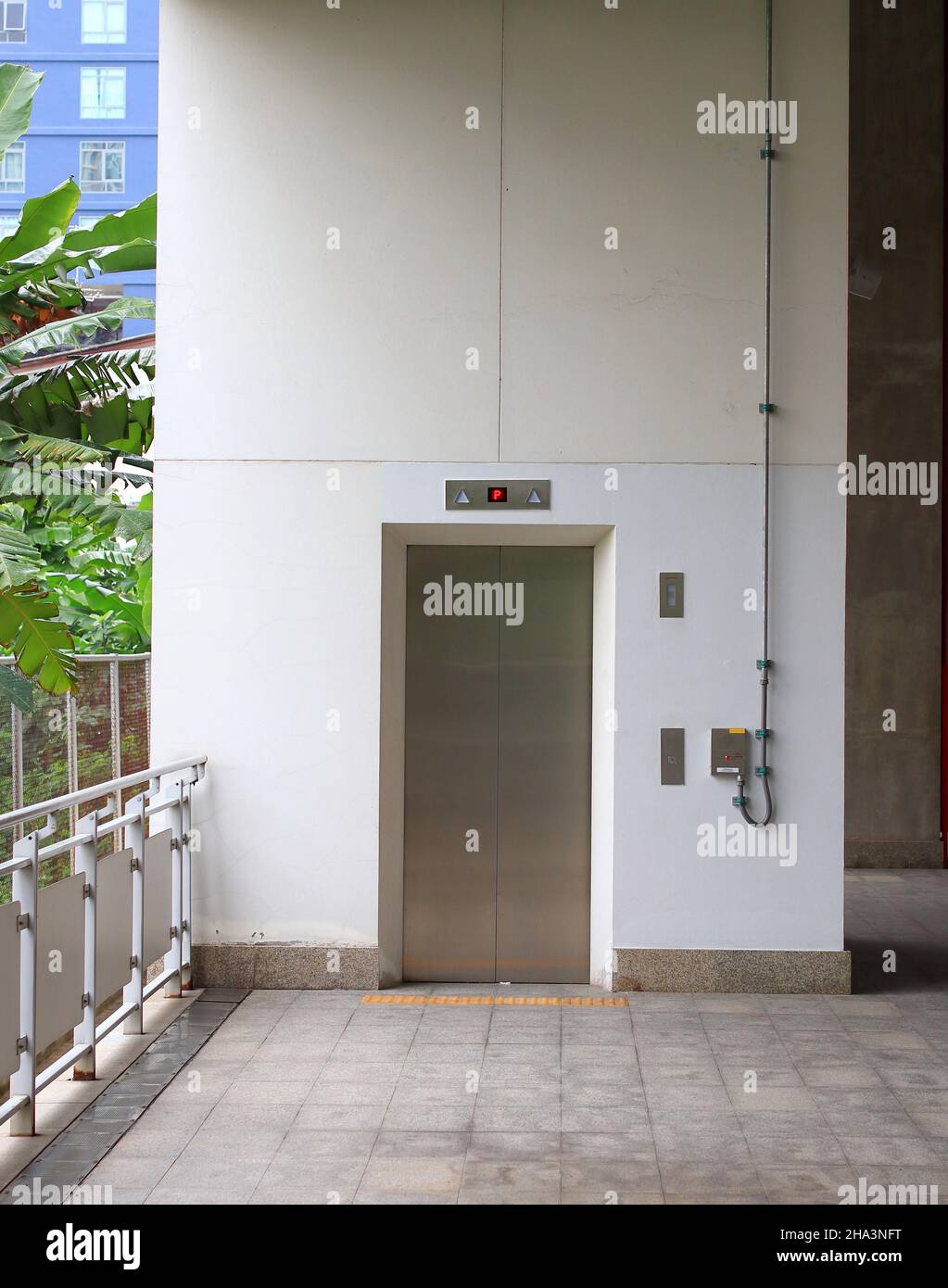 Hallway with LCD screen floor stand, Modern steel elevator cabins ...