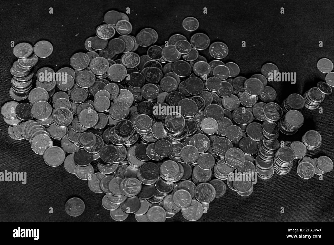 Grayscale shot of a pile of coins Stock Photo - Alamy