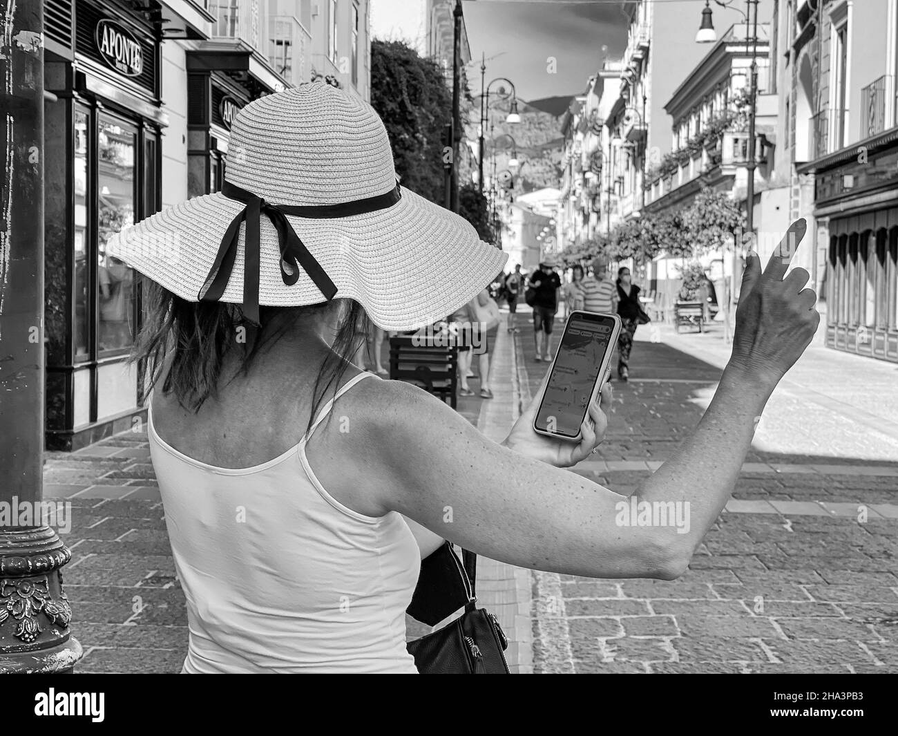 Beautiful woman catching a cab in a narrow city street Stock Photo - Alamy