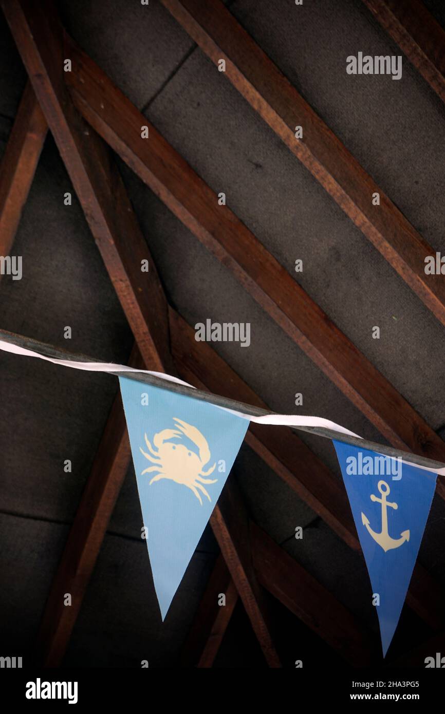 coloured bunting flags in rafters of barn Stock Photo - Alamy