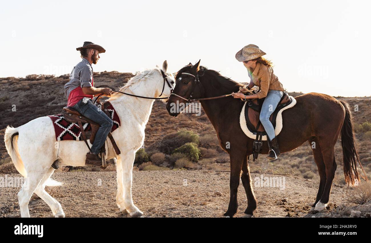 Farmers having fun riding a horses inside corral ranch Stock Photo - Alamy