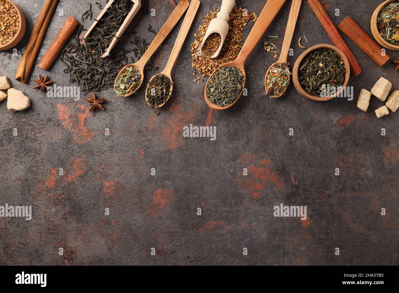Concept of cooking tea with different types of tea on dark textured ...