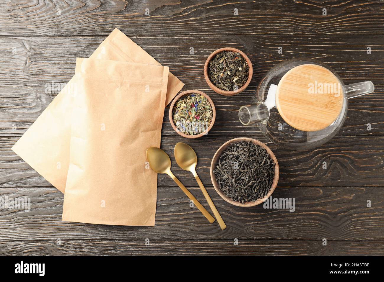 Concept of cooking tea with different types of tea on wooden background ...
