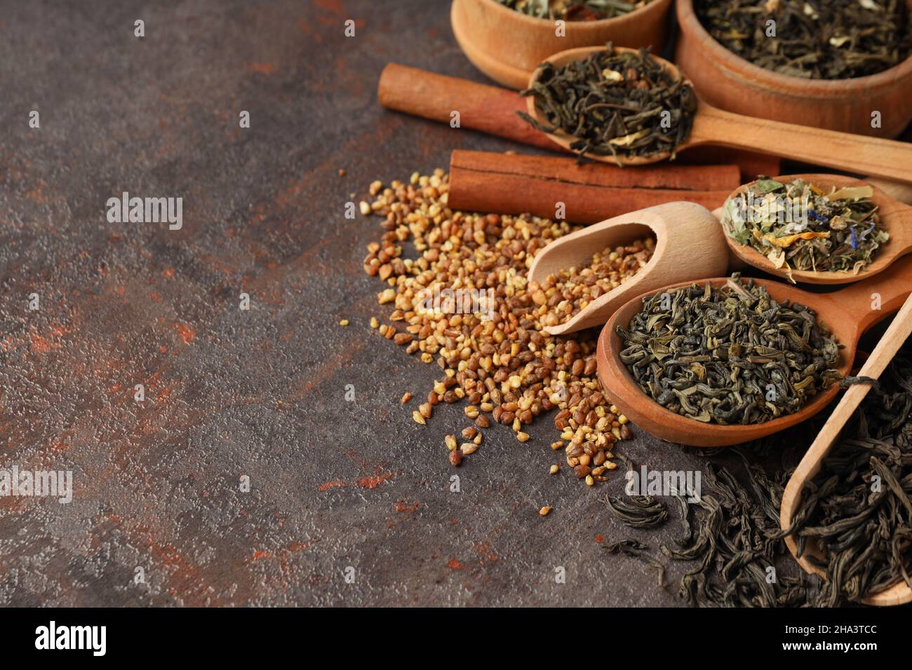 Concept of cooking tea with different types of tea on dark textured ...