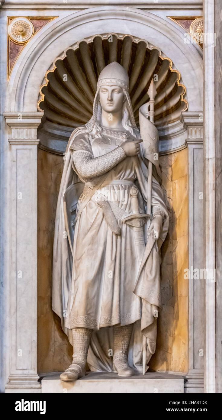 Marble statue of medieval soldier decorating niche inside old building ...