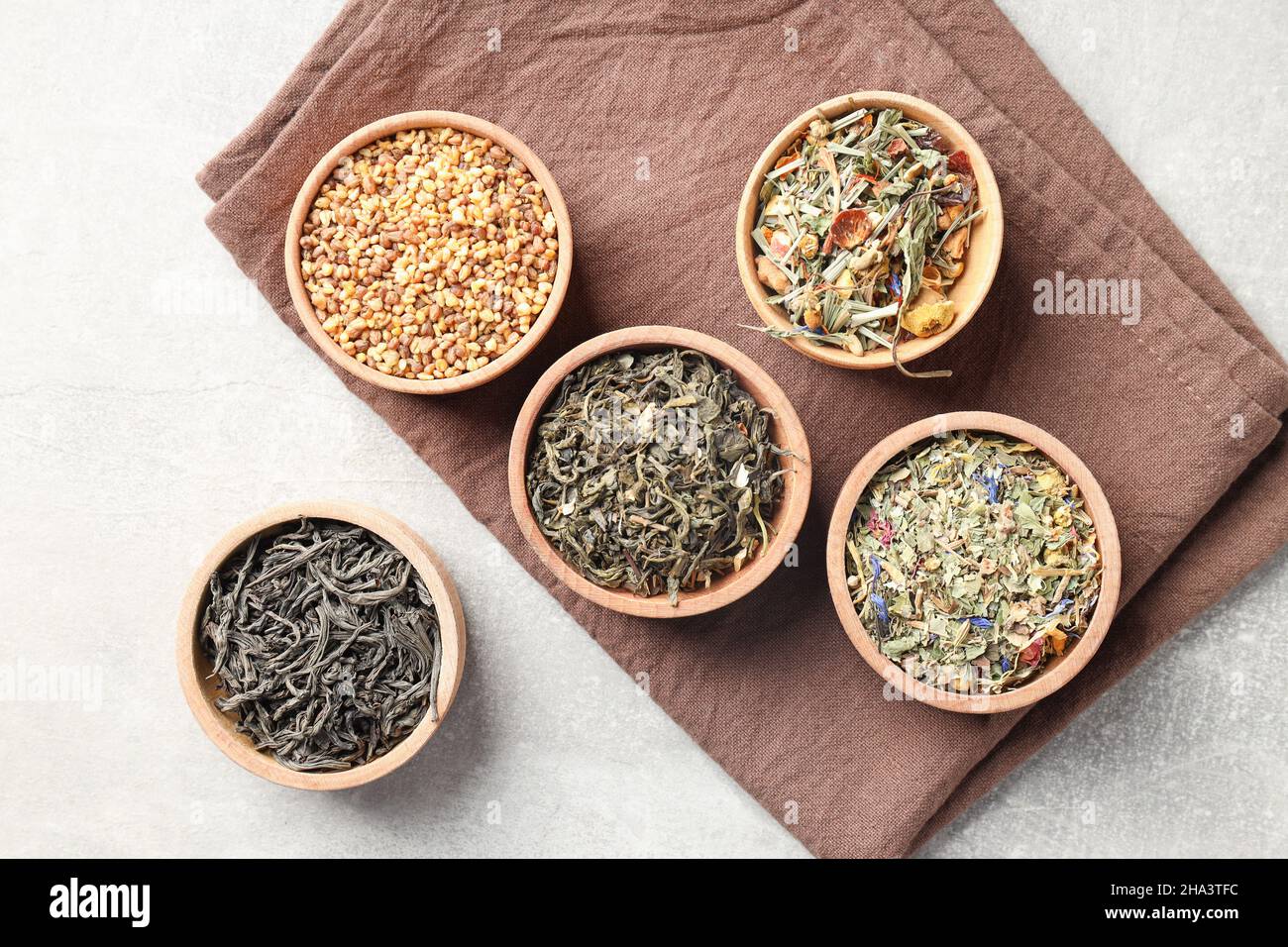 Concept of cooking tea with different types of tea on light textured ...