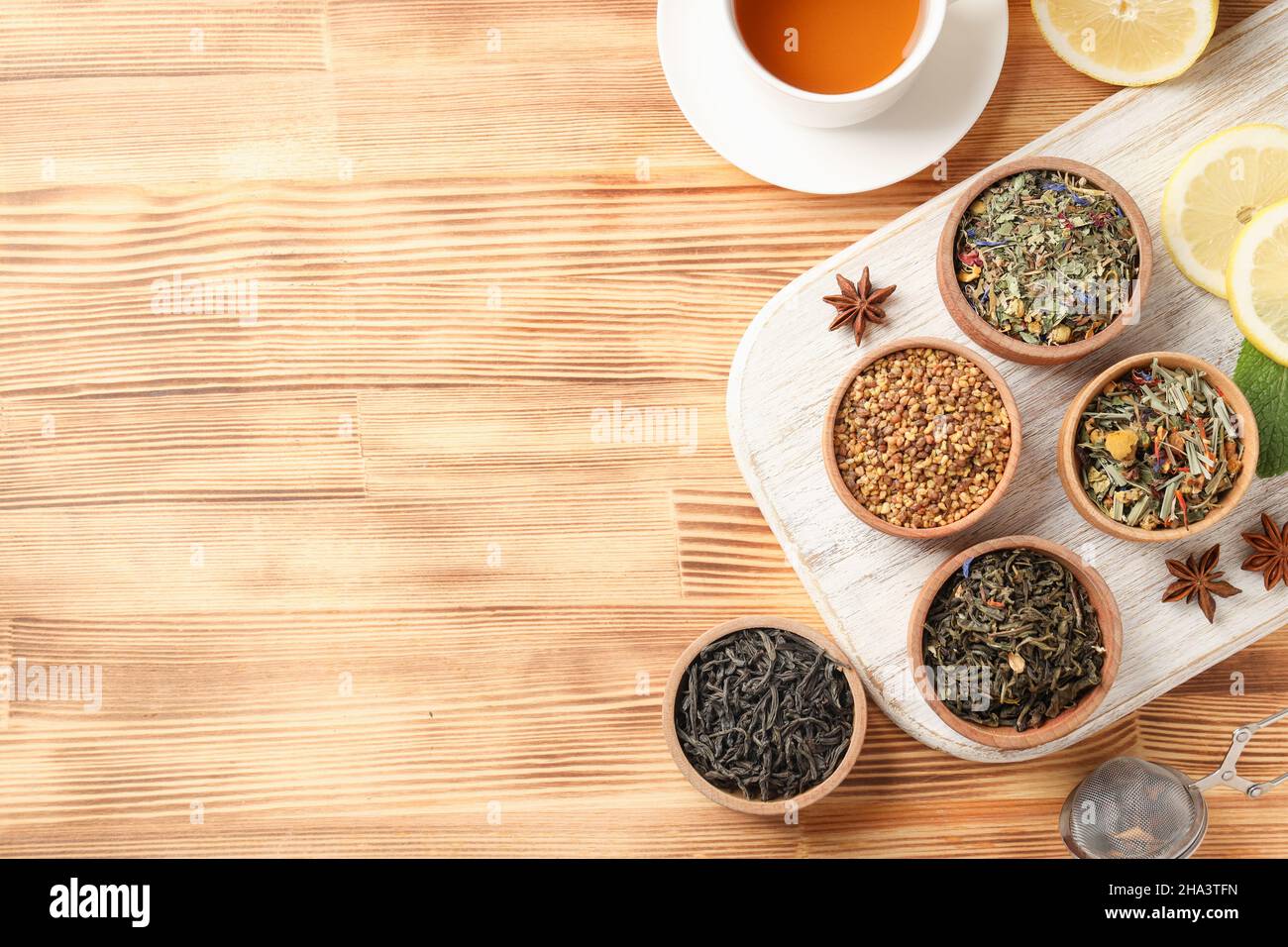 Concept of cooking tea with different types of tea on wooden background ...