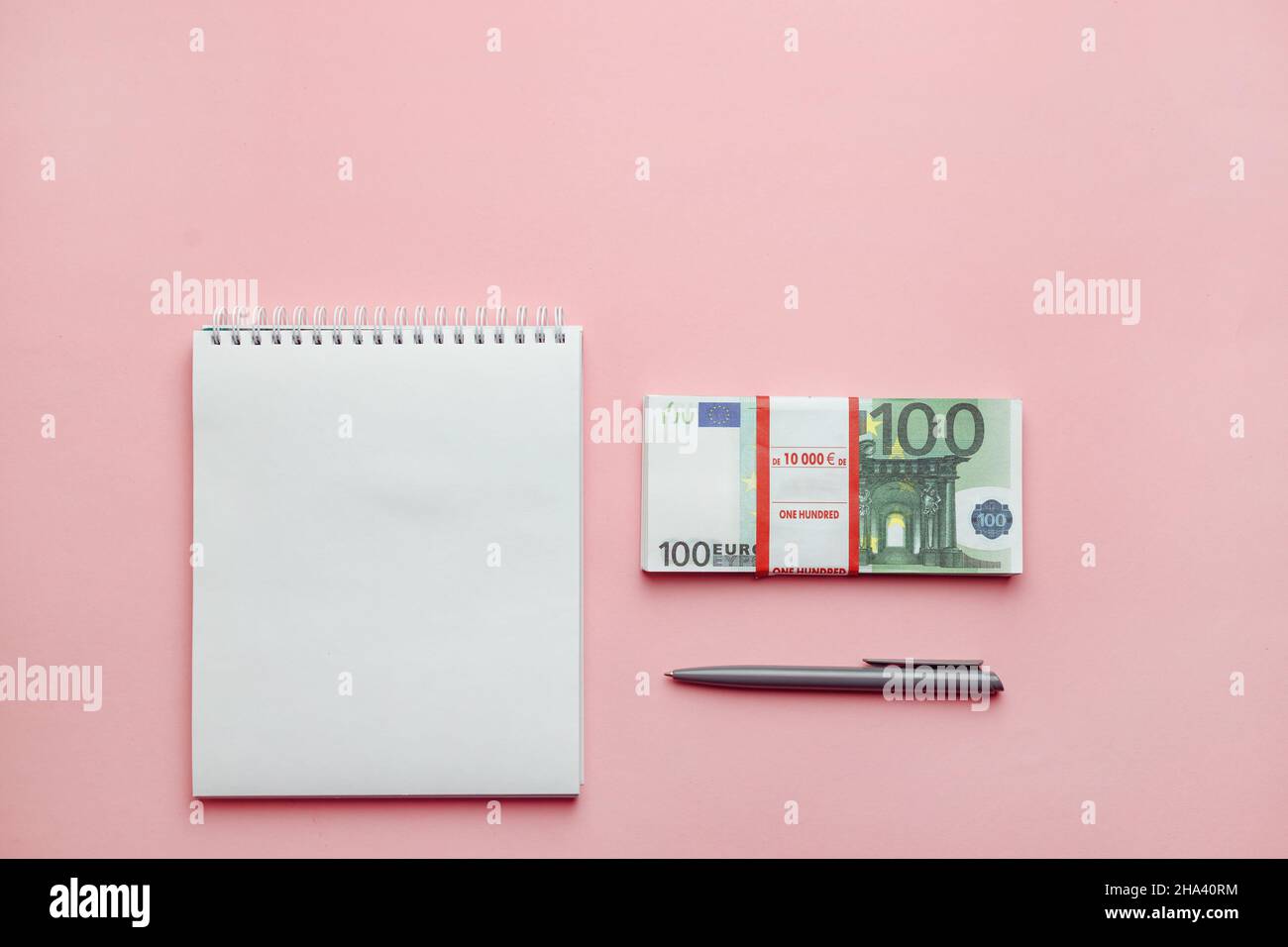 Investment and budget planning concept. Notepad, pen and bundle of ...