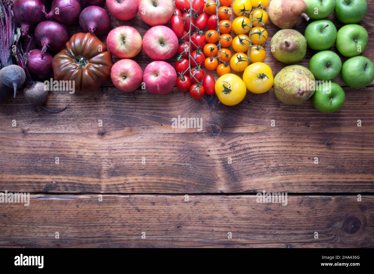 Selection of fruits and vegetables with rainbow colours on a rustic ...