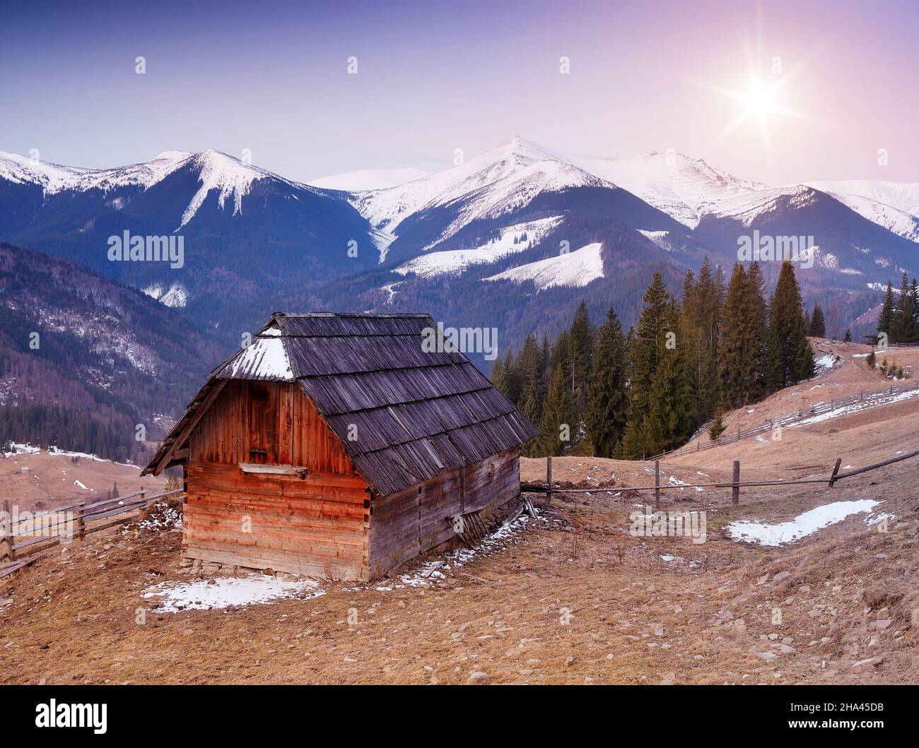 Spring landscape with small wooden house for hay Stock Photo - Alamy