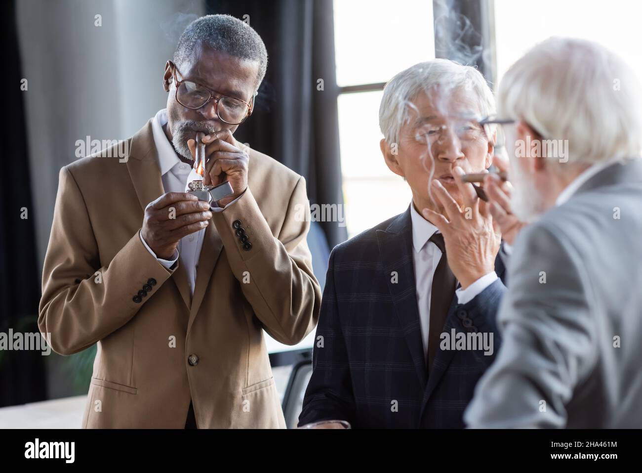 successful senior multiethnic business partners smoking cigars in office Stock Photo - Alamy