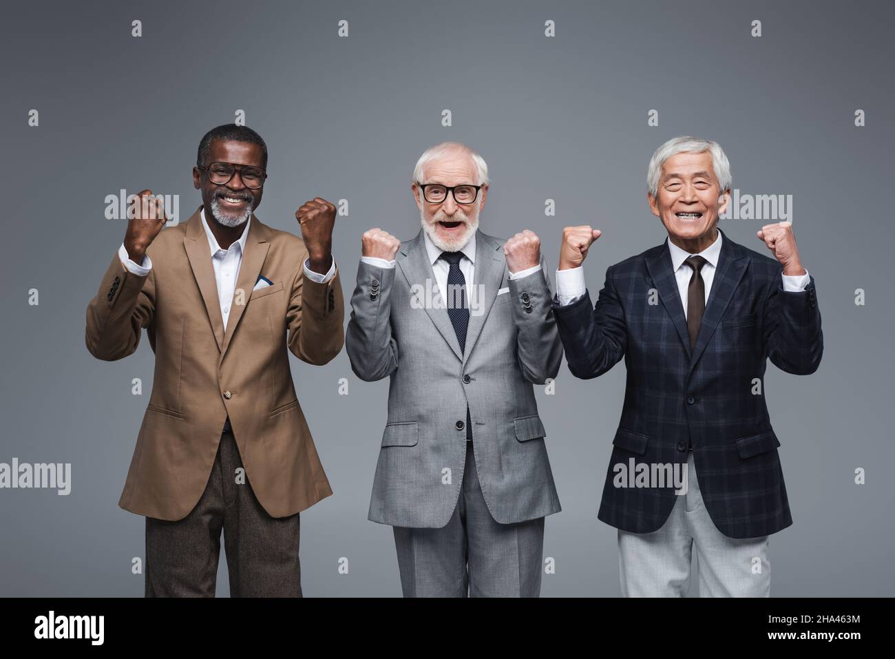 successful multicultural businessmen showing triumph gesture isolated ...