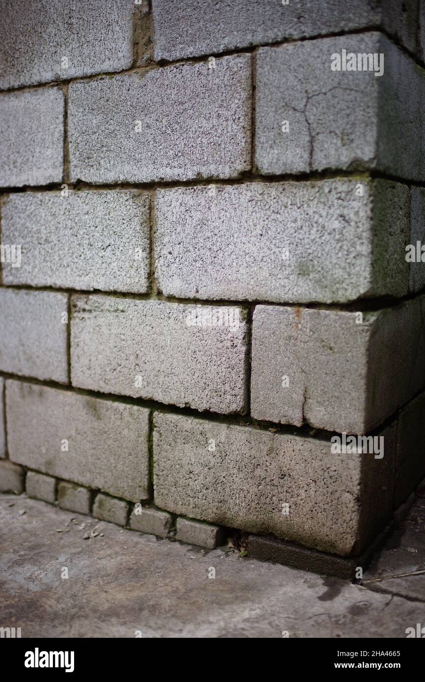 Grey cinder block wall with wet seams. Perspective view Stock Photo - Alamy