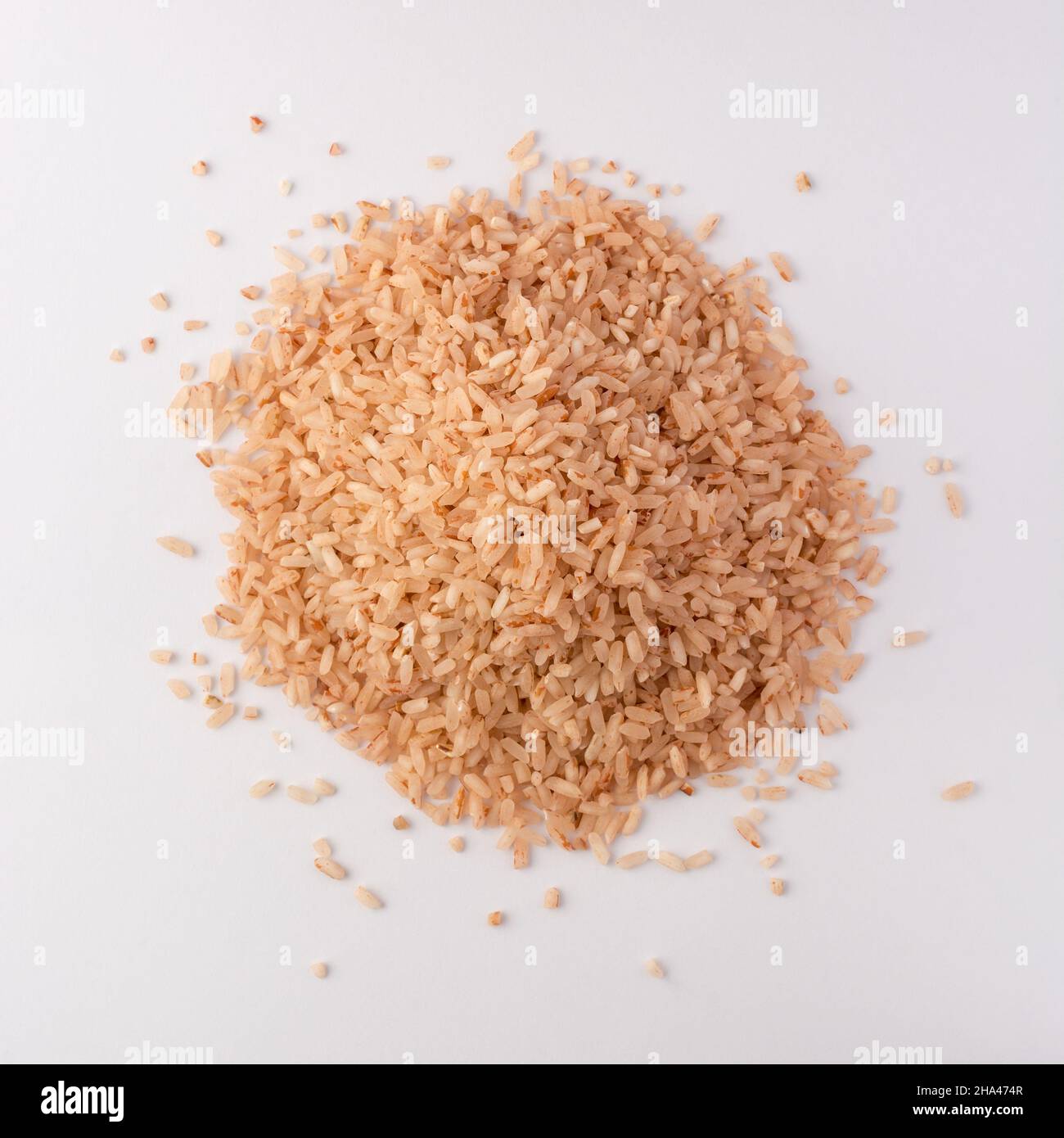 pile of whole grain brown rice isolated on white background, closeup ...