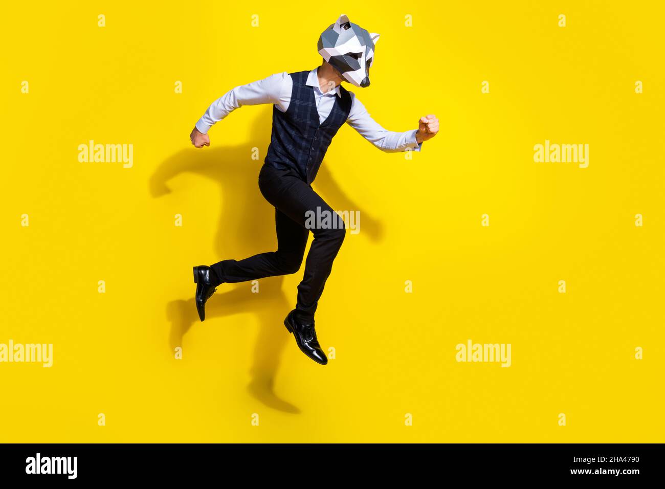 Full length profile side photo of weird absurd guy racoon mask jump run ...