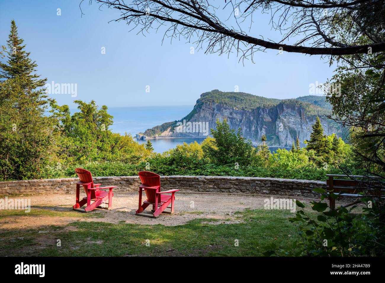 Point of view over Forillon national park at dusk, two empty adirondack ...