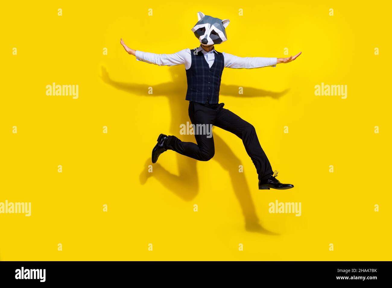 Photo of surreal absurd authentic guy racoon mask jump fly arms ...