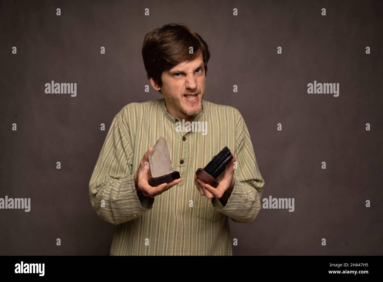 Young handsome tall slim white man with brown hair angrily holding ...