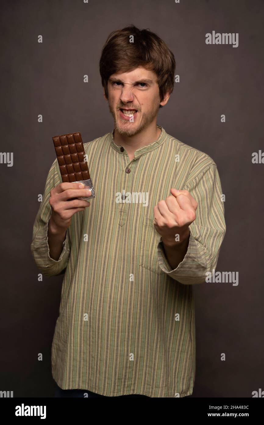 Young handsome tall slim white man with brown hair angrily holding ...