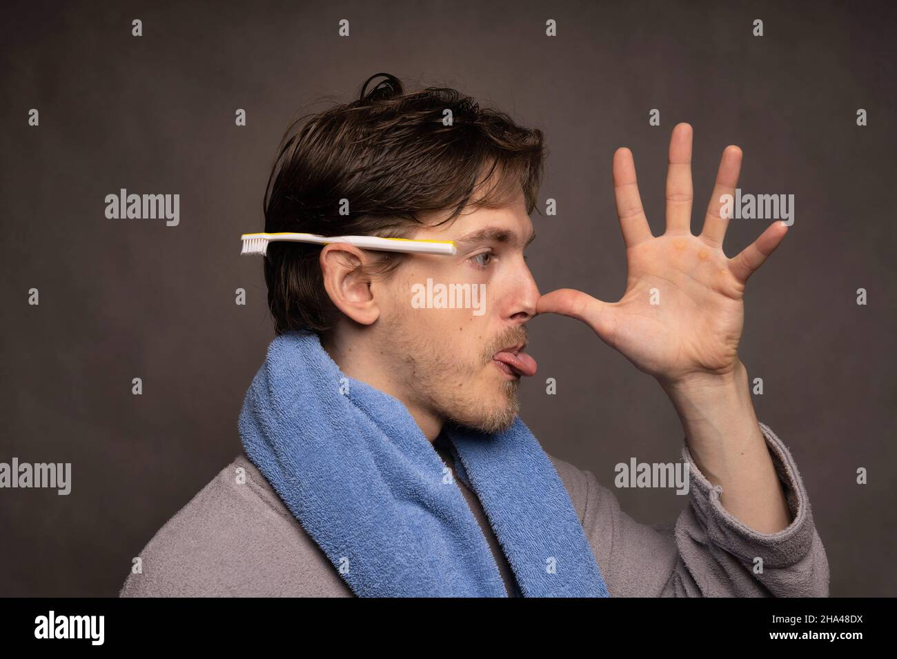 Young handsome tall slim white man with brown hair blowing a raspberry ...