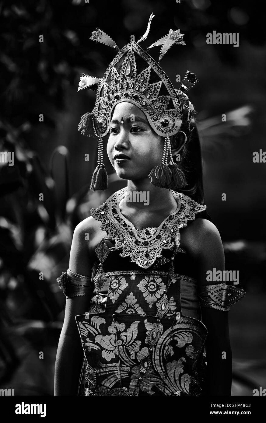 A portrait of a young Balinese female dancer at her family compound in ...