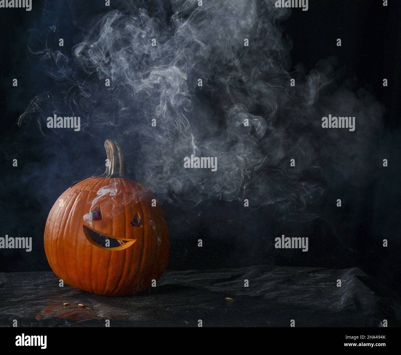 Carved Halloween pumpkin with smoke coming out of holes Stock Photo - Alamy