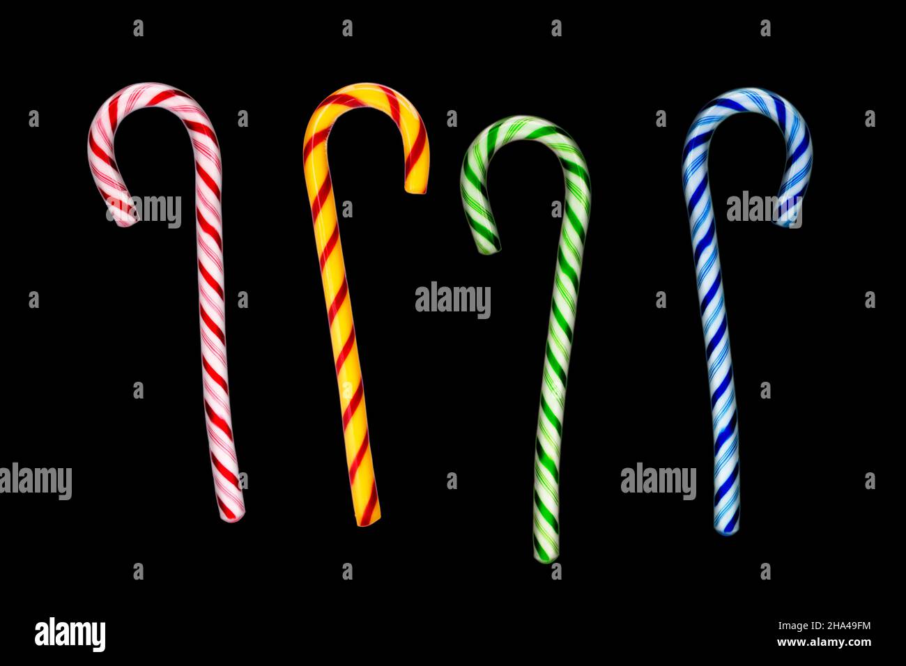 colorful candy canes isolated against dark background Stock Photo - Alamy