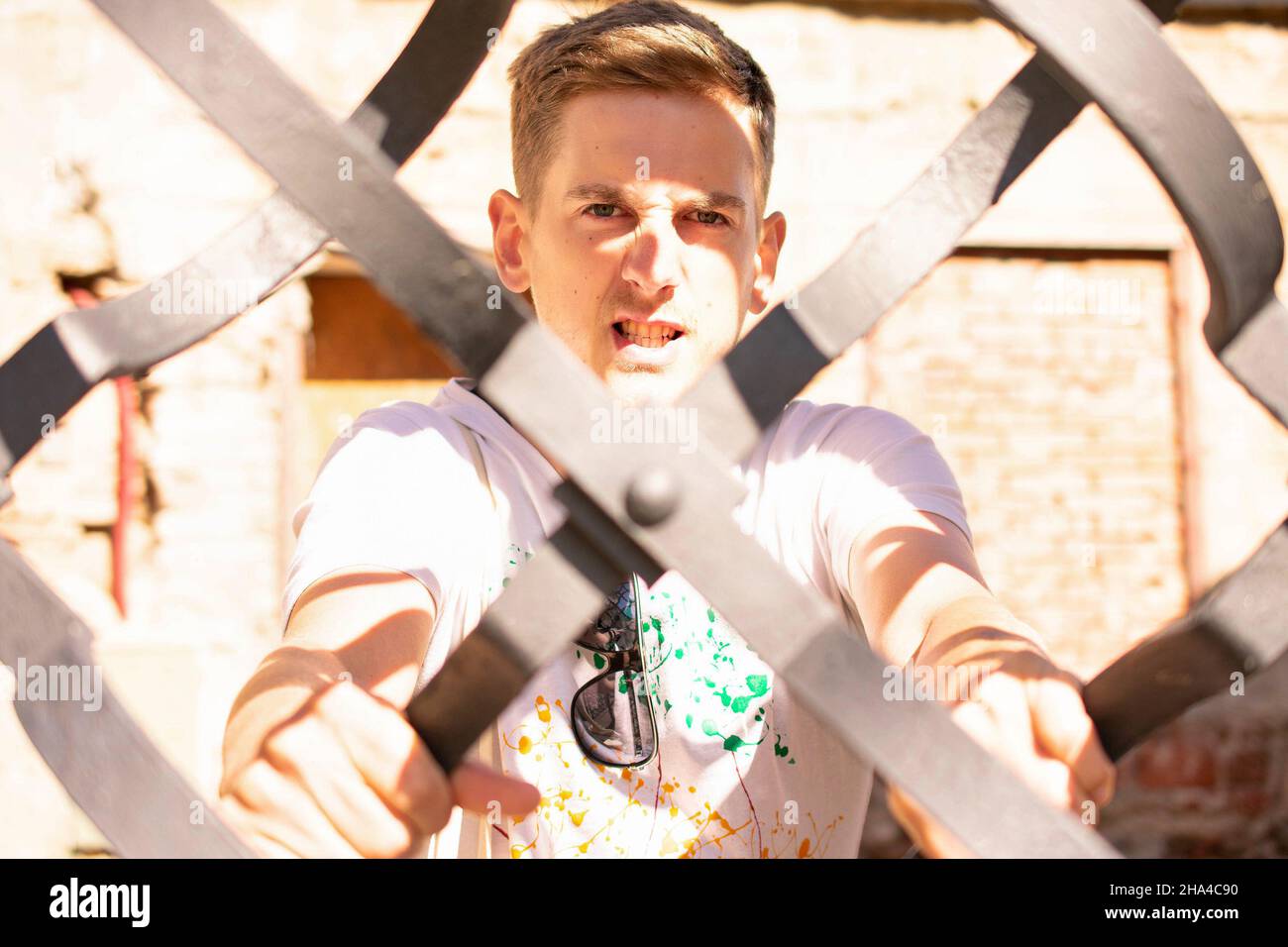 Young handsome white man with brown hair in white shirt is behind the ...