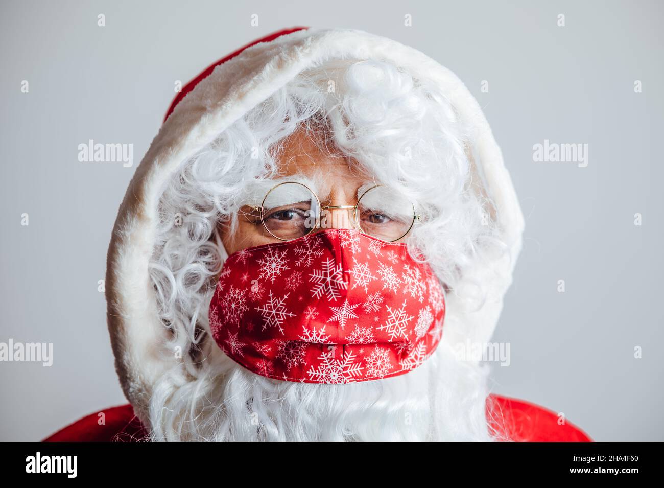 Santa Claus with a red face mask with snowflakes Stock Photo - Alamy