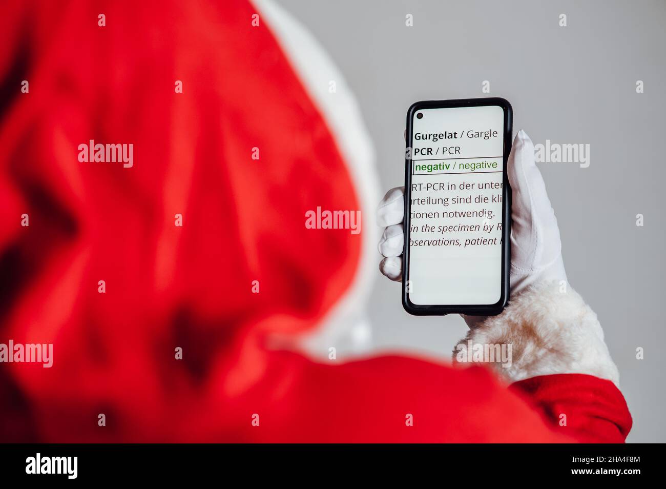 Santa Claus looking at his negative PCR test result on his phone Stock ...
