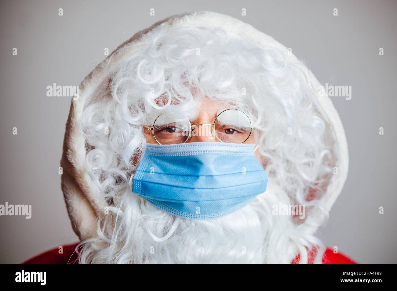 Santa wearing a blue face mask Stock Photo - Alamy