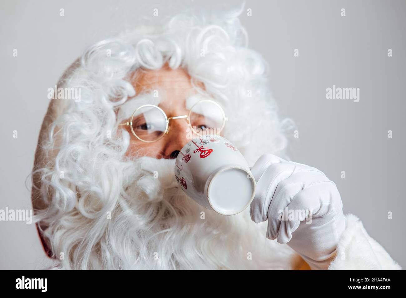 Santa Claus drinking coffee from a festive cup Stock Photo - Alamy