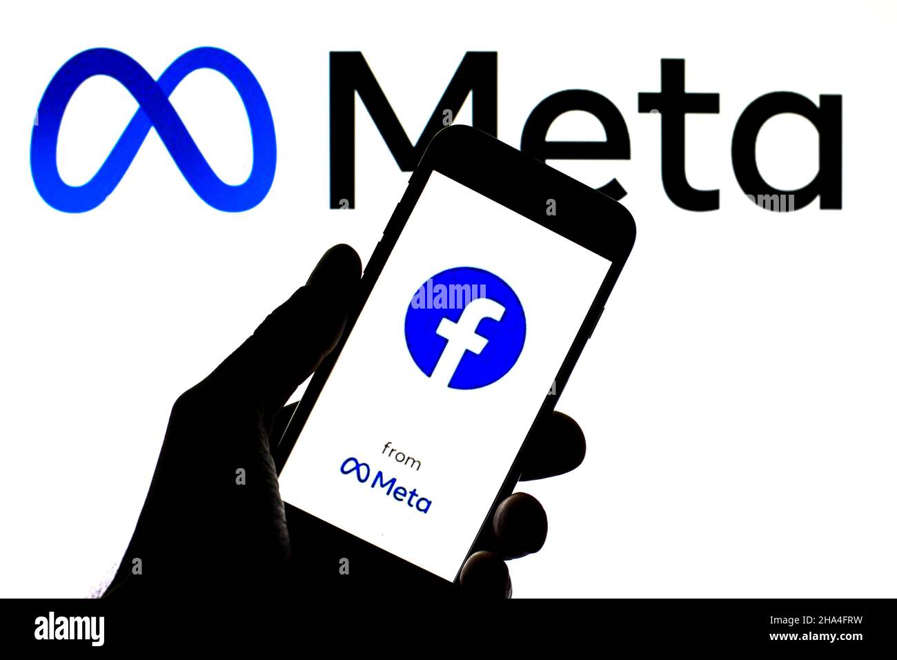 In this photo illustration a Facebook and Meta logo seen displayed on a ...