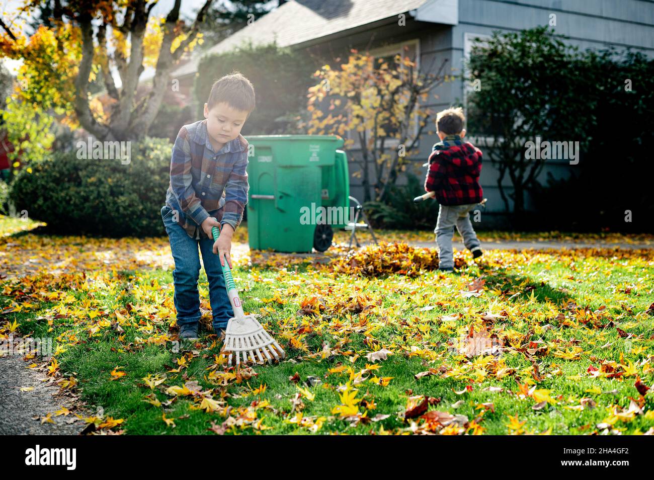 Child raking leaves asian hi-res stock photography and images - Alamy