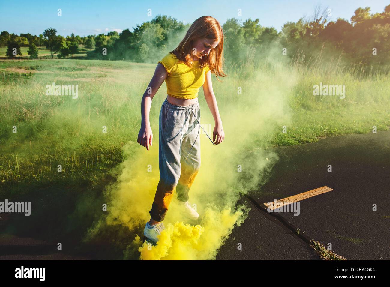 Cool tween girl skateboarding with smokebomb Stock Photo - Alamy