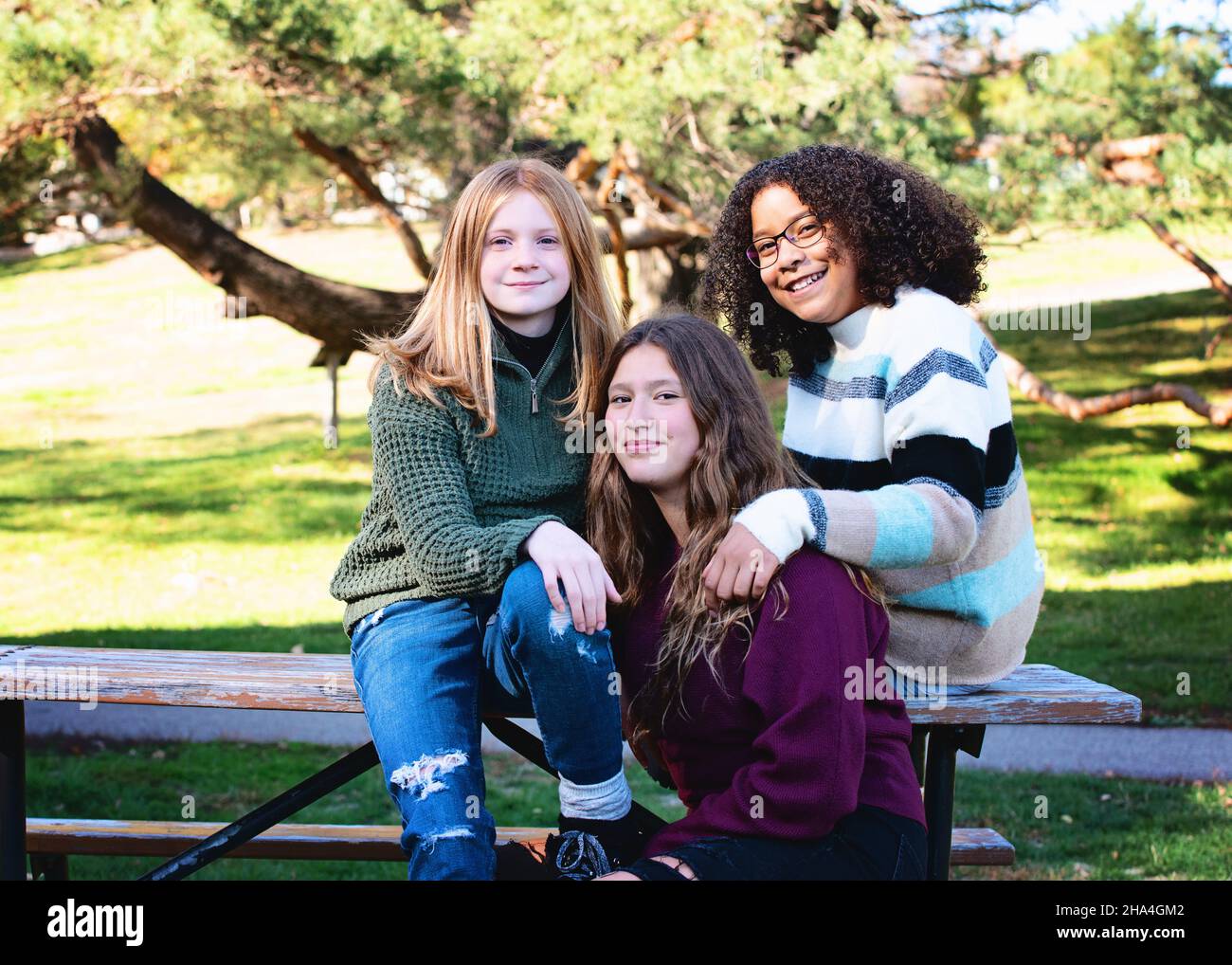 Three happy tween girls outdoors at a park Stock Photo - Alamy