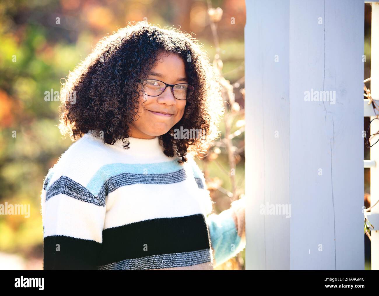 Smiling tween girl outdoors in fall colors Stock Photo - Alamy