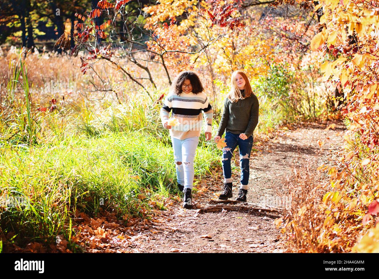 Two tween girls walking outdoors in fall colors Stock Photo - Alamy