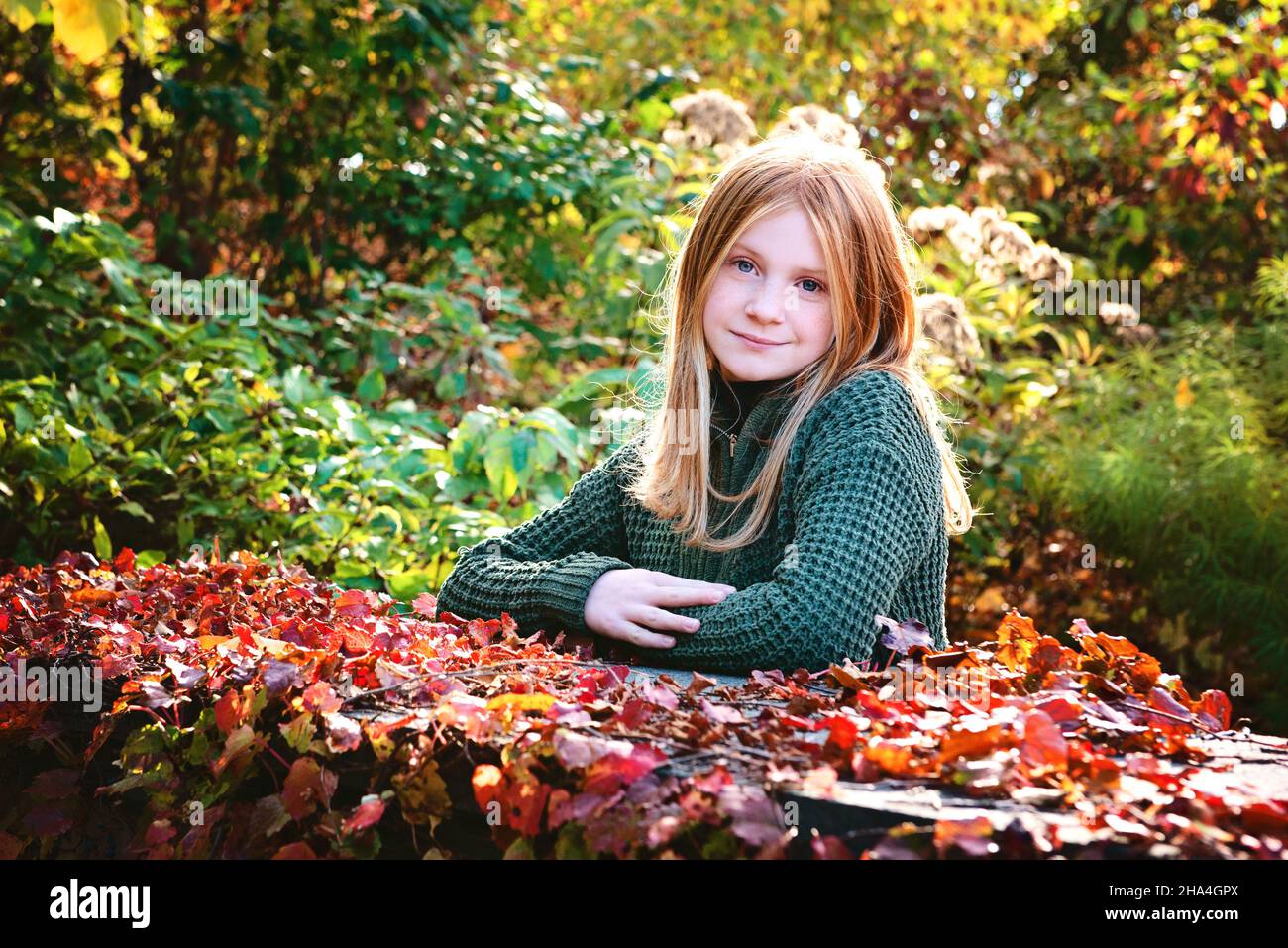 Happy tween girl with red hair outdoors in fall colors Stock Photo - Alamy