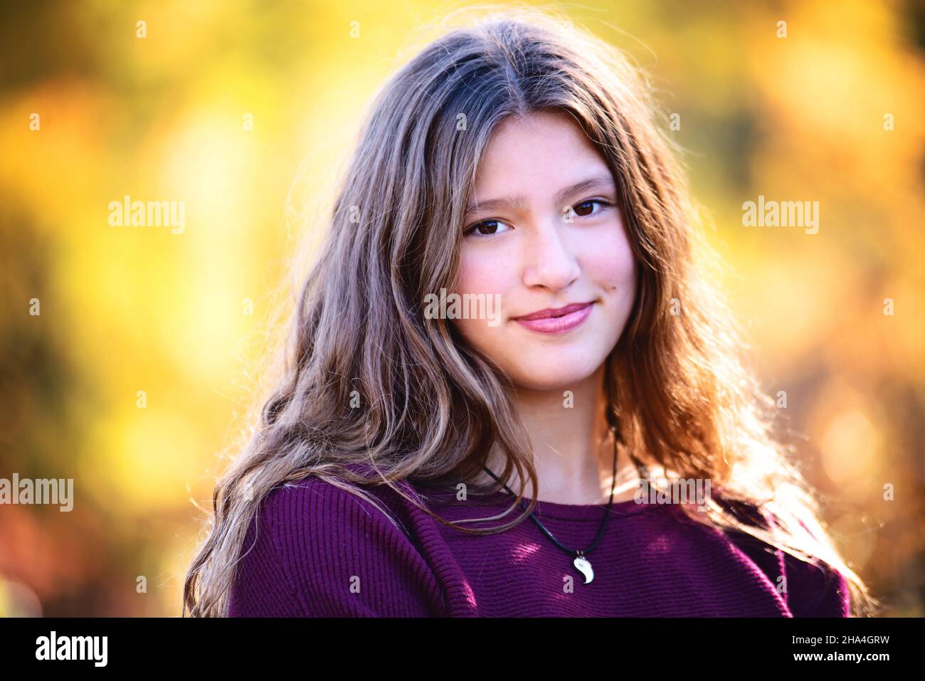 Beautiful happy tween girl outdoors in fall colors Stock Photo - Alamy