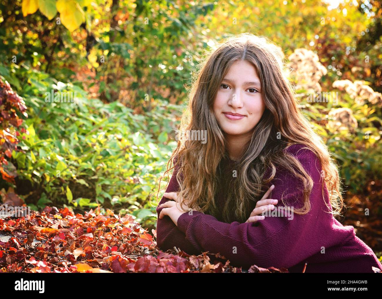 Beautiful smiling tween girl outdoors in fall colors Stock Photo - Alamy