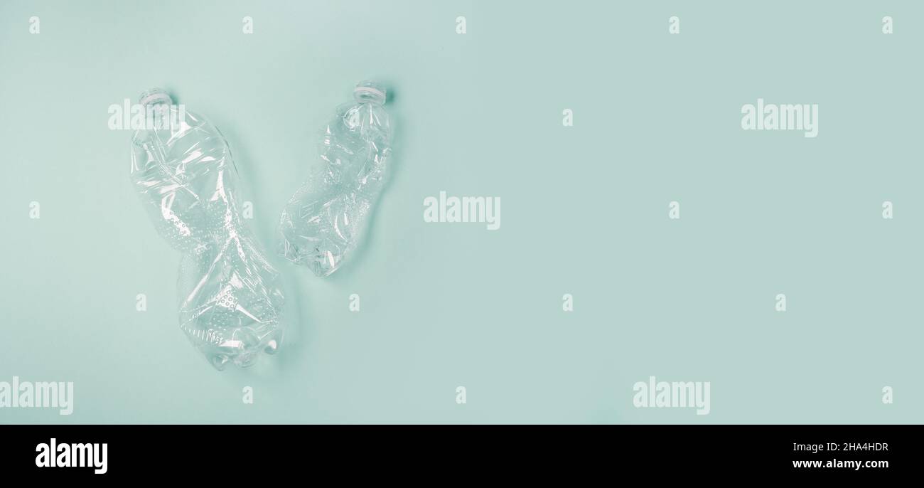 Used rumpled plastic bottles on green background. Ecology problem. Top ...