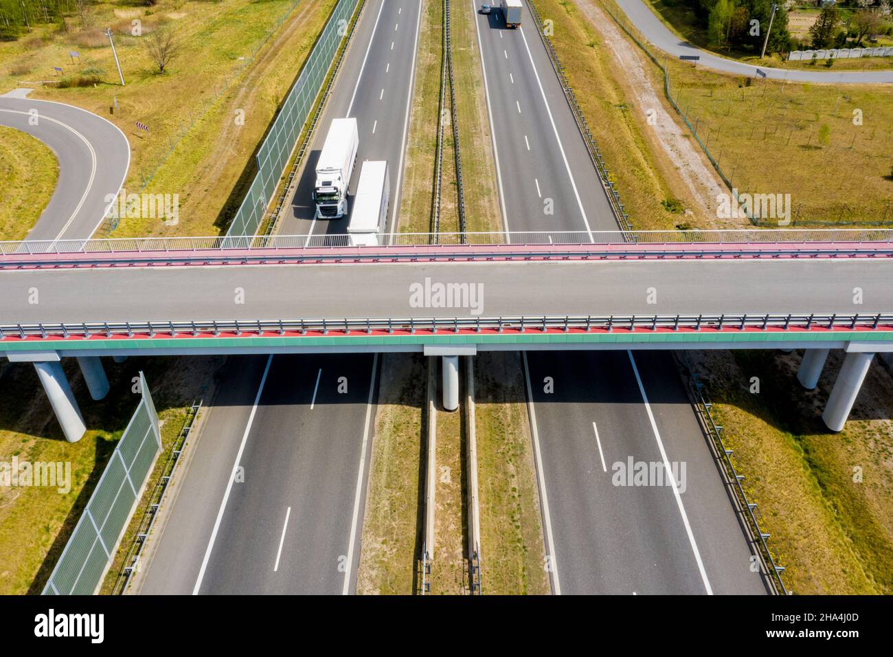 Cars and freight semi truck driving on busy highway across the country ...
