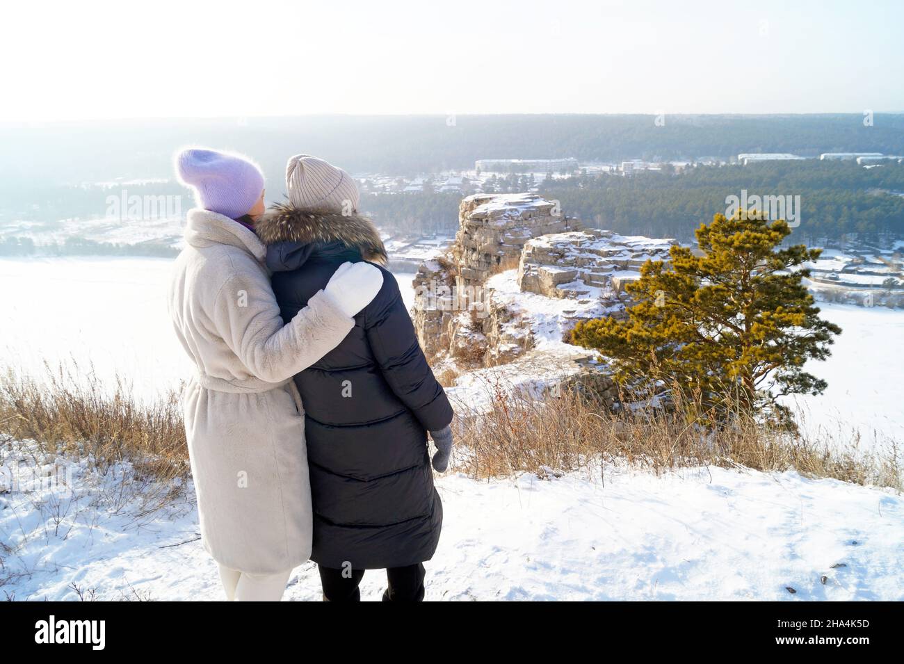 Women hugging each other stand in front of White Rocks on the Belaya ...