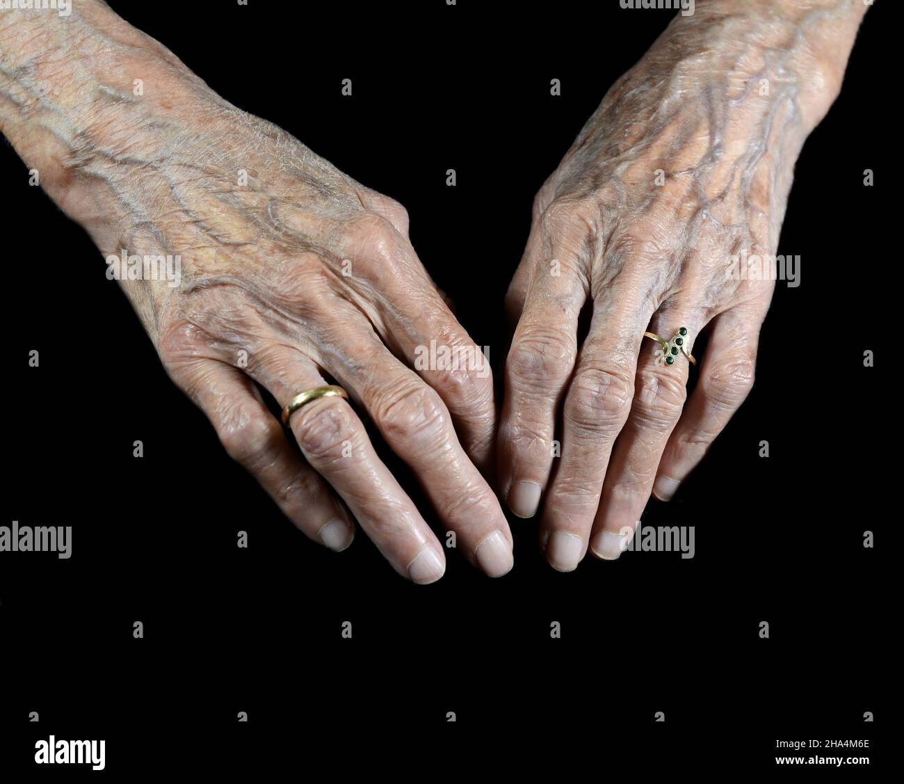 Aging process - very old senior woman hands isolated on black ...