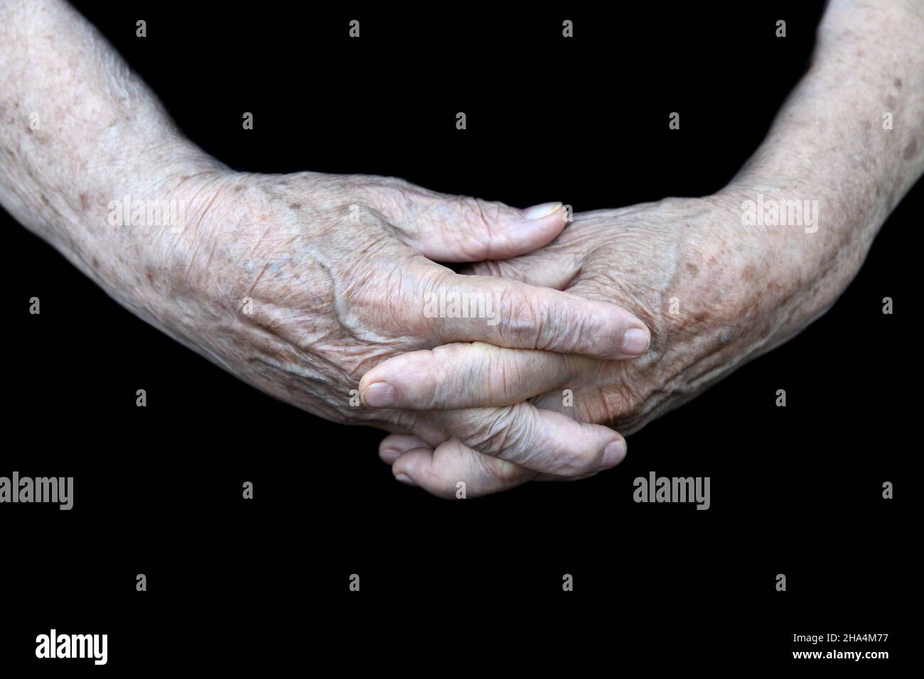 Aging process - very old senior woman hands isolated on black ...